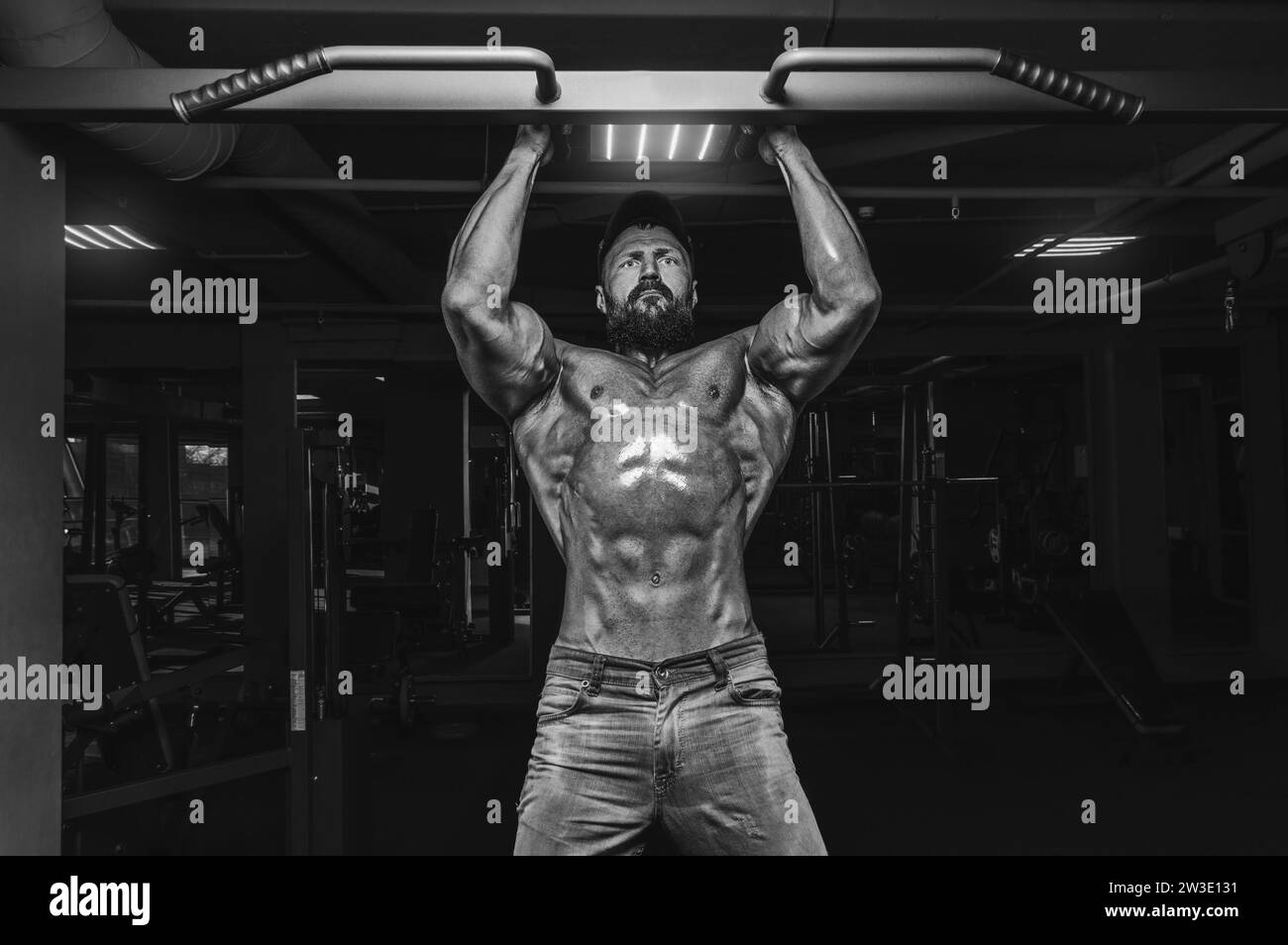 Muscular athlete pulls up in the gym. Fitness and bodybuilding concept ...