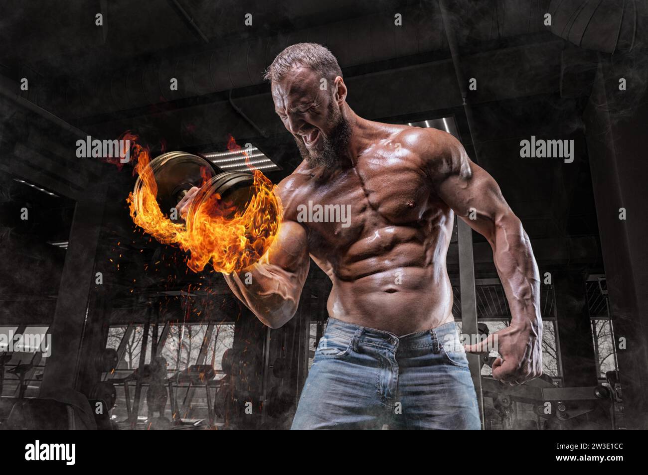 Professional athlete trains with a fire dumbbell in the gym. Bicep ...