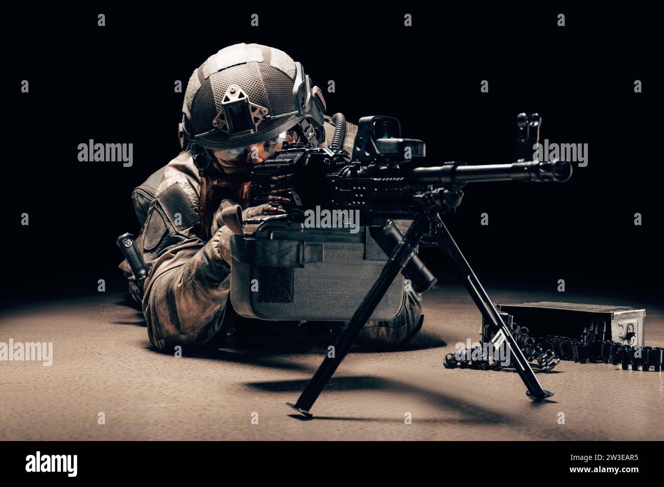 Portrait of a fighter of a special unit. He lies on the ground and ...