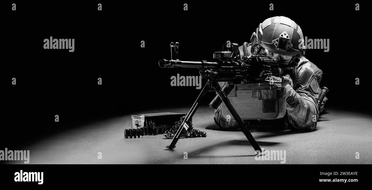 Portrait of a fighter of a special unit. He lies on the ground and ...