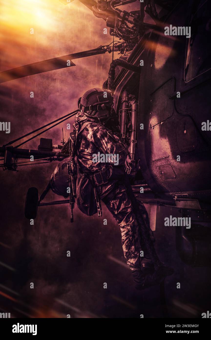 Image of a military man attached with a rope to a helicopter ...