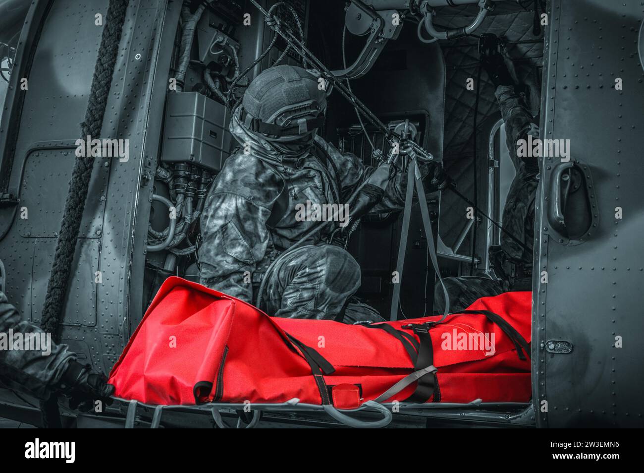 Evacuation of a wounded soldier by helicopter. The victim lies on a ...