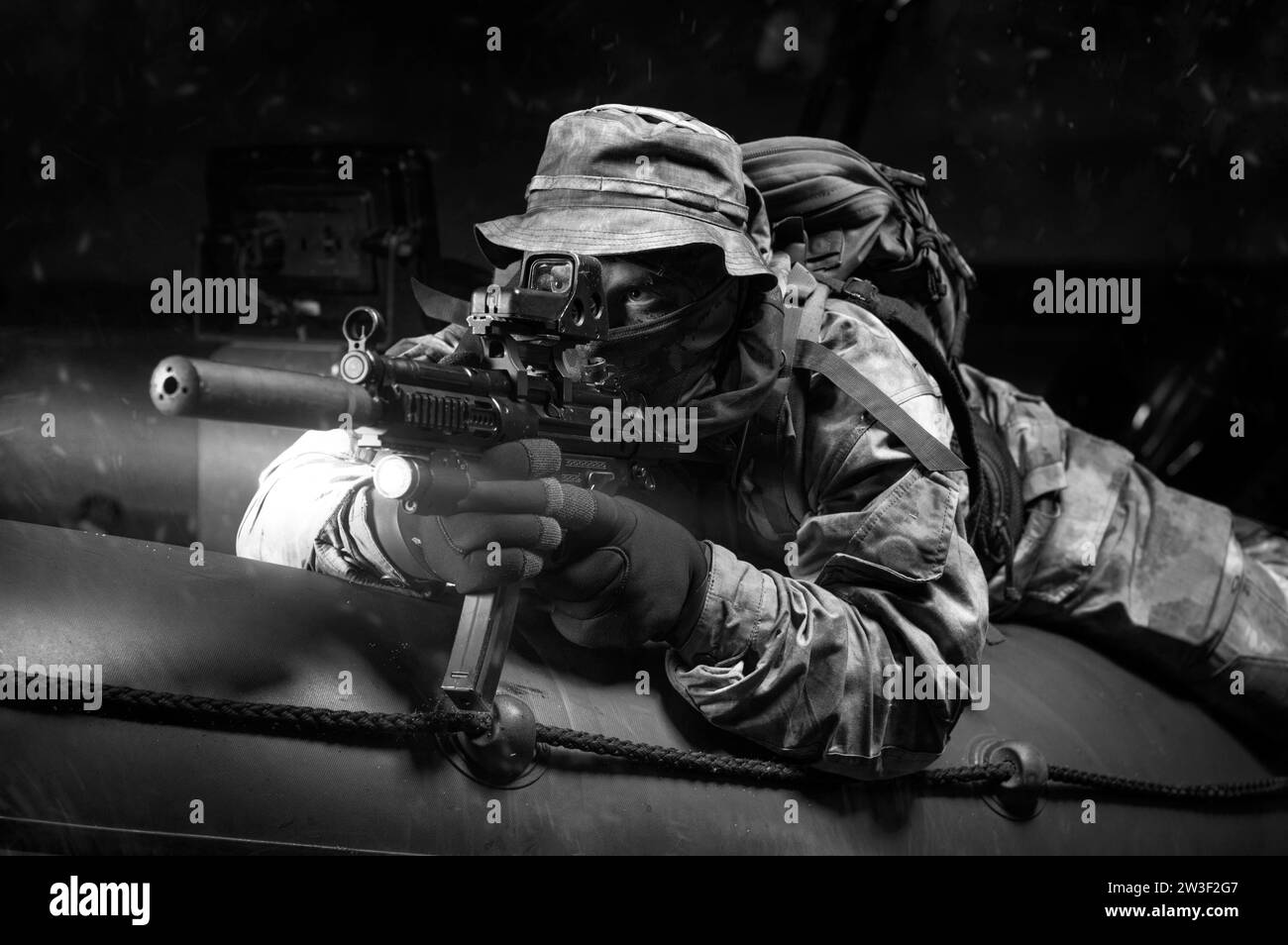 Two fighters of a special unit move at night on the river in a boat ...