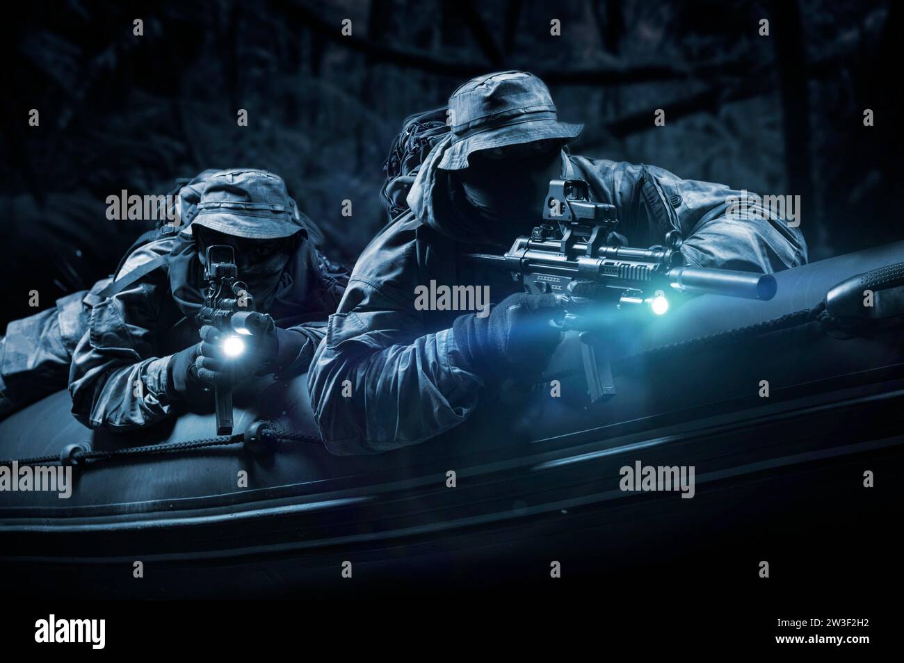Two fighters of a special unit move through the forest at night. The ...