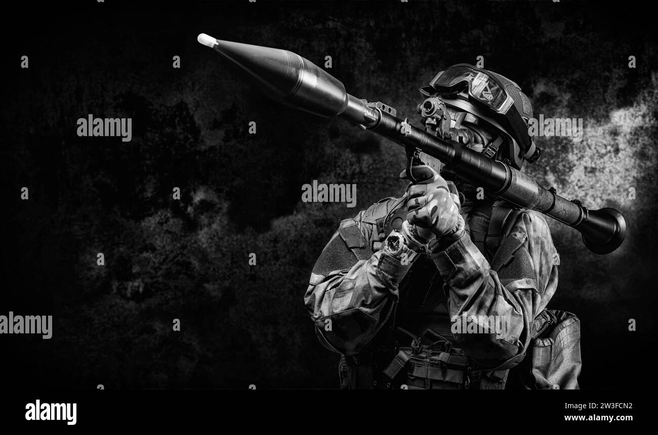 American soldier is aiming at an RPG sight against a dark background ...