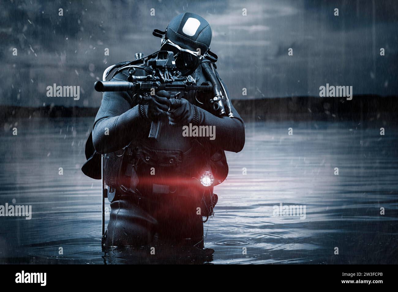 SWAT unit soldier stands waist-deep in water with a machine gun in his ...