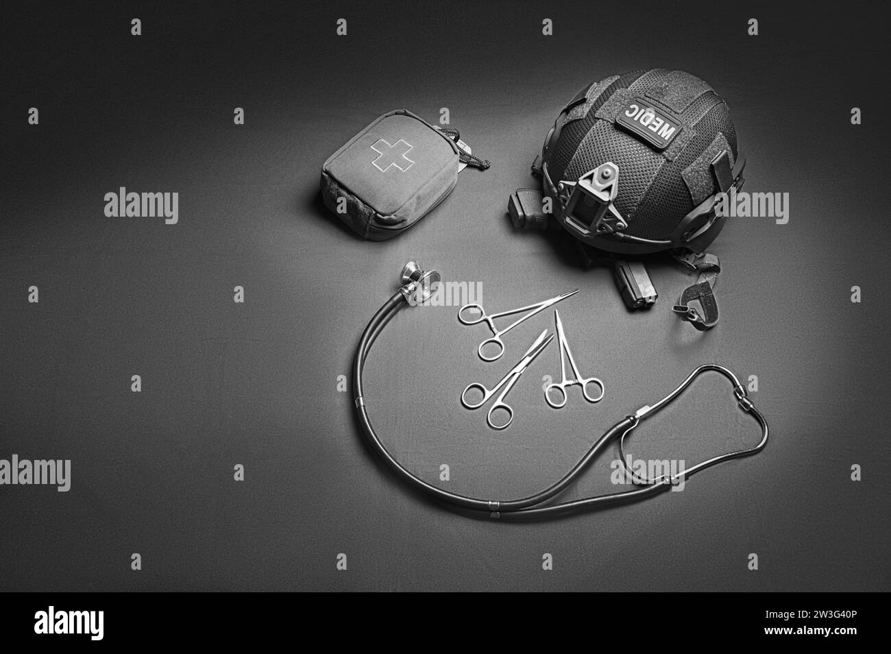First aid kit, phonendoscope, a set of scissors with a helmet lie on a ...