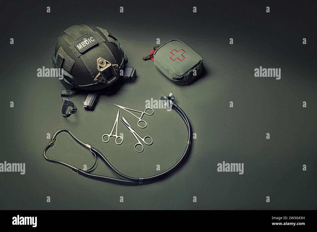 First aid kit, phonendoscope, a set of scissors with a helmet lie on a ...