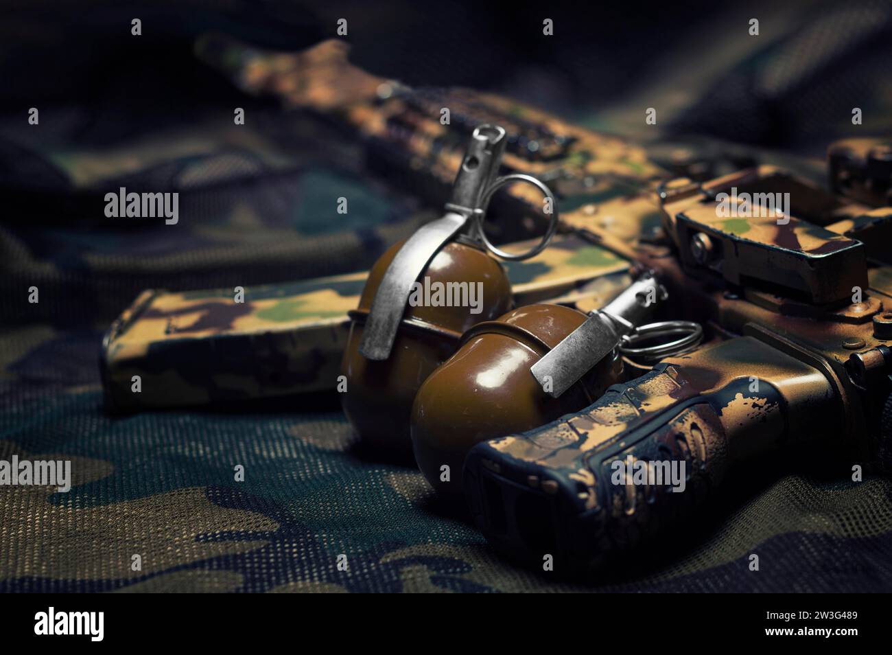 Two grenades lie on a camouflage background. The concept of military ...