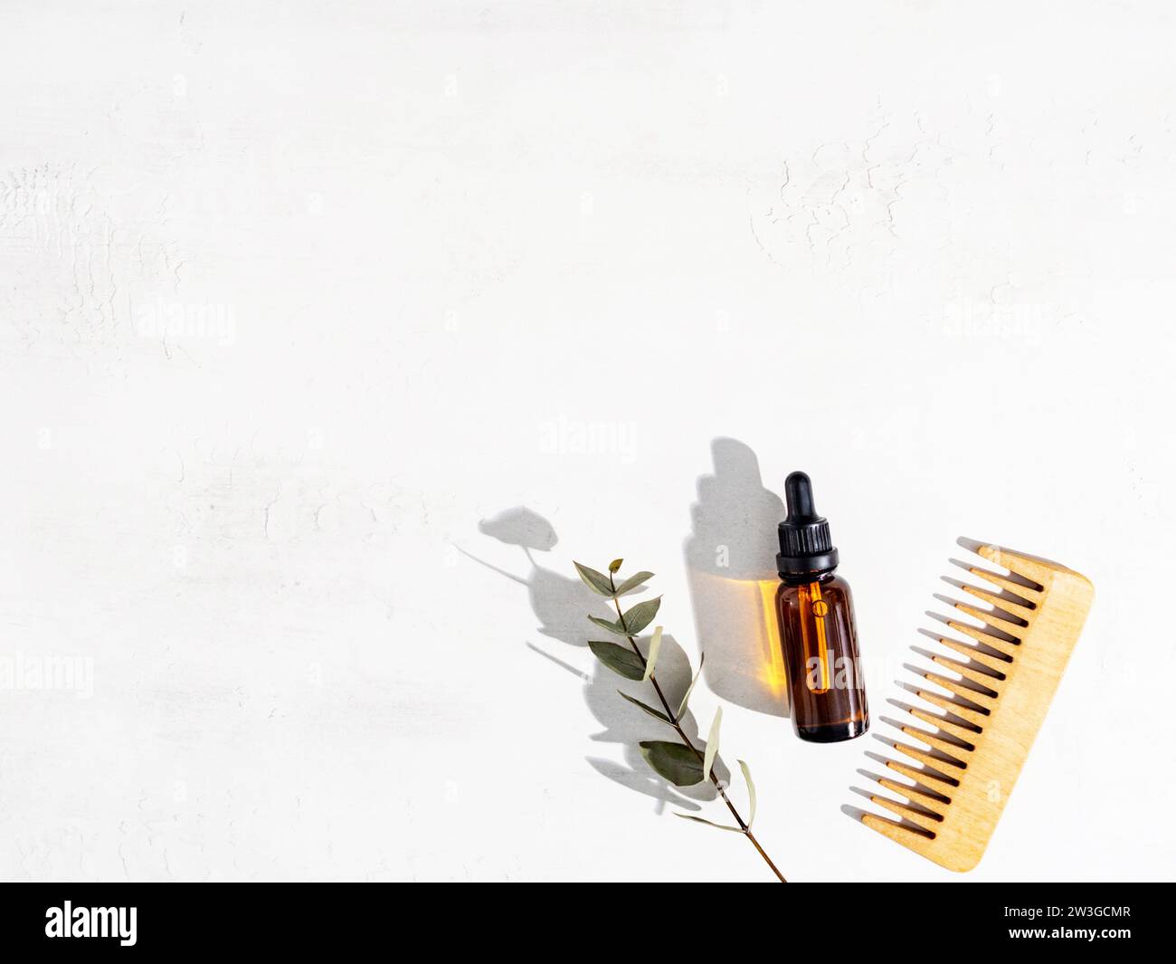 Essential oil for hair care with wooden hair comb and bamboo comb on ...