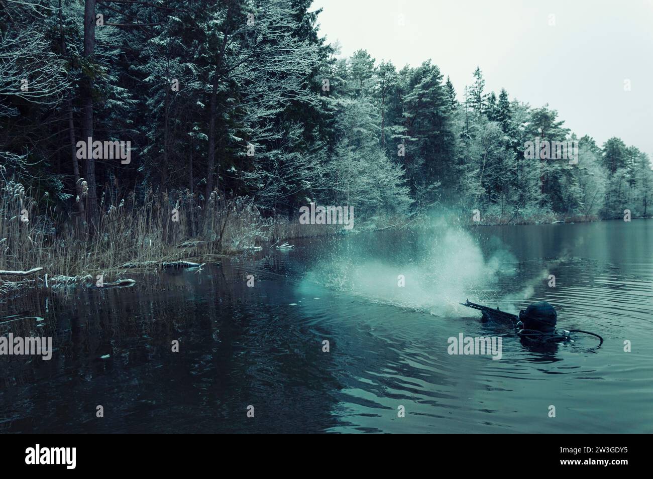 Military diver fires a special weapon in the water. The concept of ...