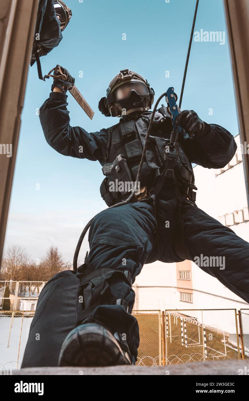 Special forces soldier storms the building through the window. Training ...
