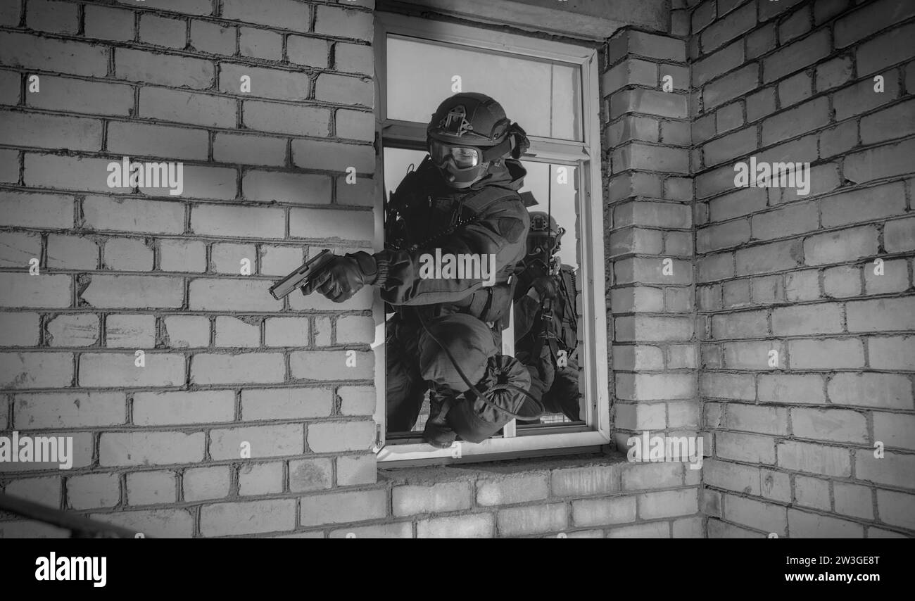 Group of special forces fighters storm the building through the window ...