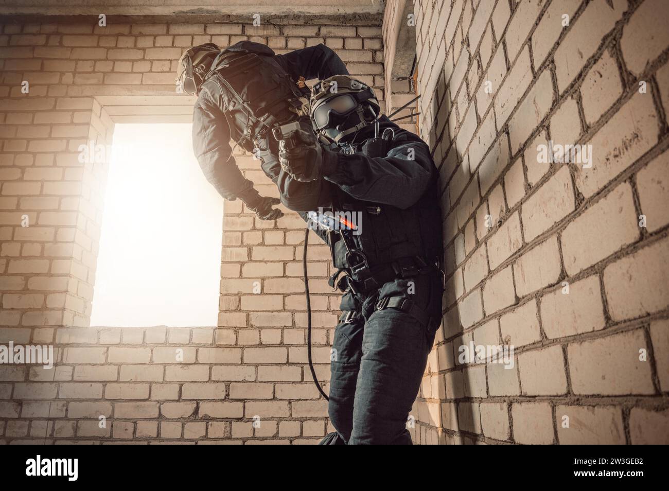 Group of special forces fighters storm the building through the window ...