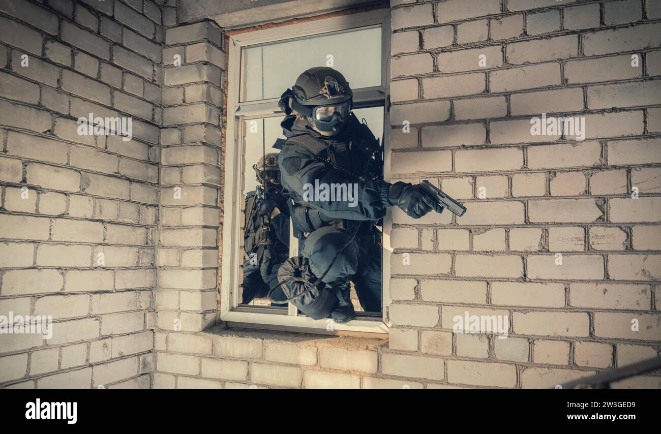 Group of special forces fighters storm the building through the window ...