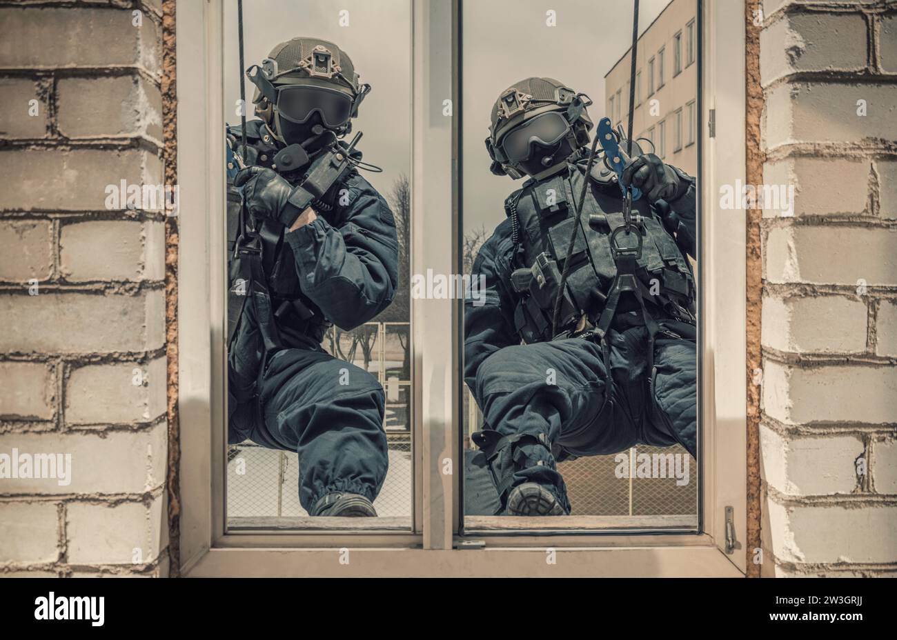 Group of special forces fighters storm the building through the window ...