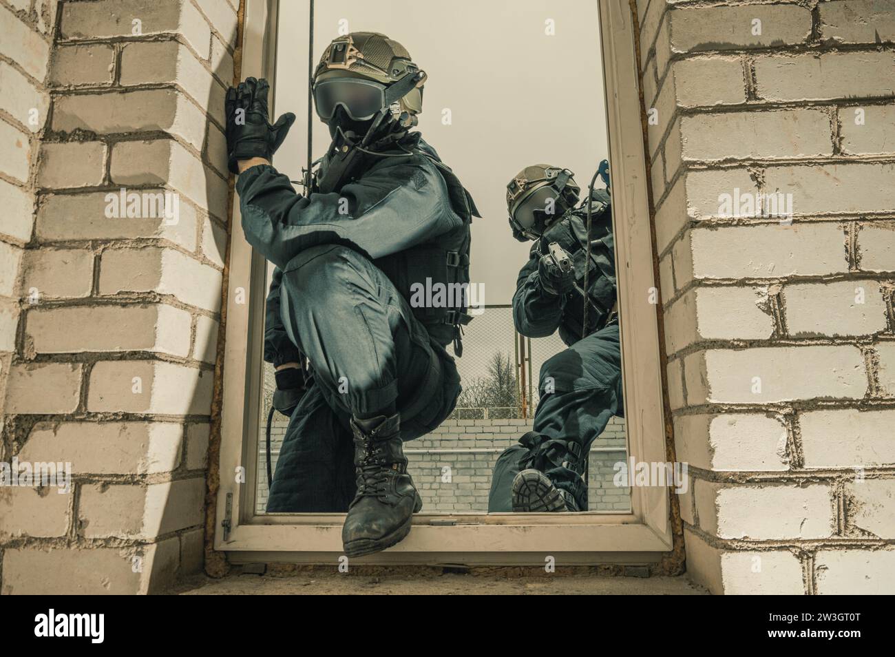 Group of special forces fighters storm the building through the window ...