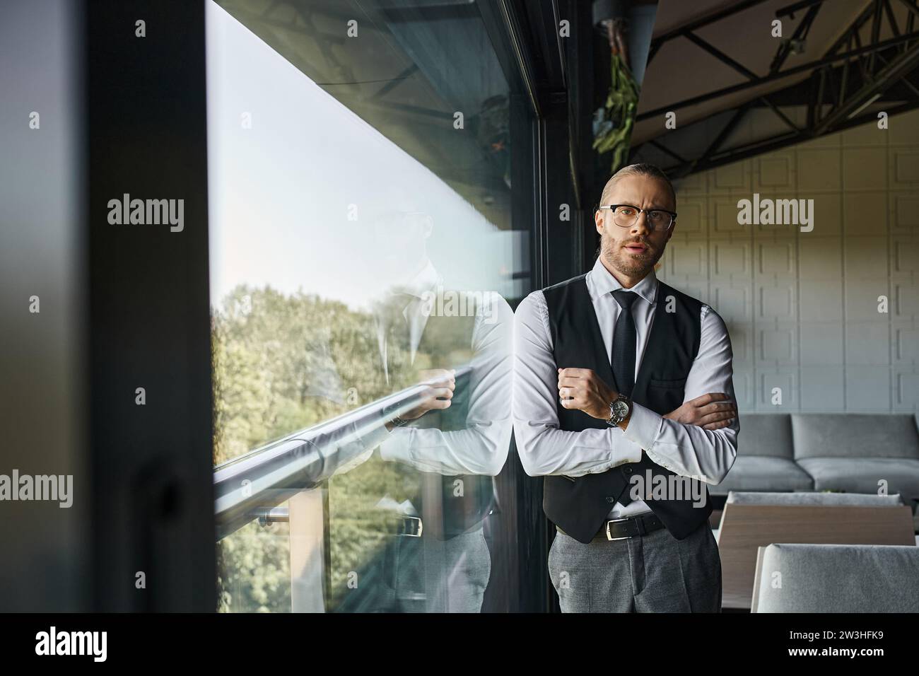 good looking businessman in black smart vest and tie looking at camera ...