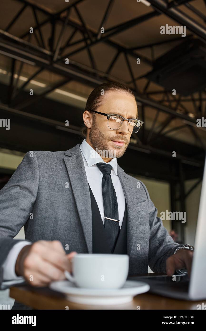 good looking businessman with dapper style with glasses drinking tea ...