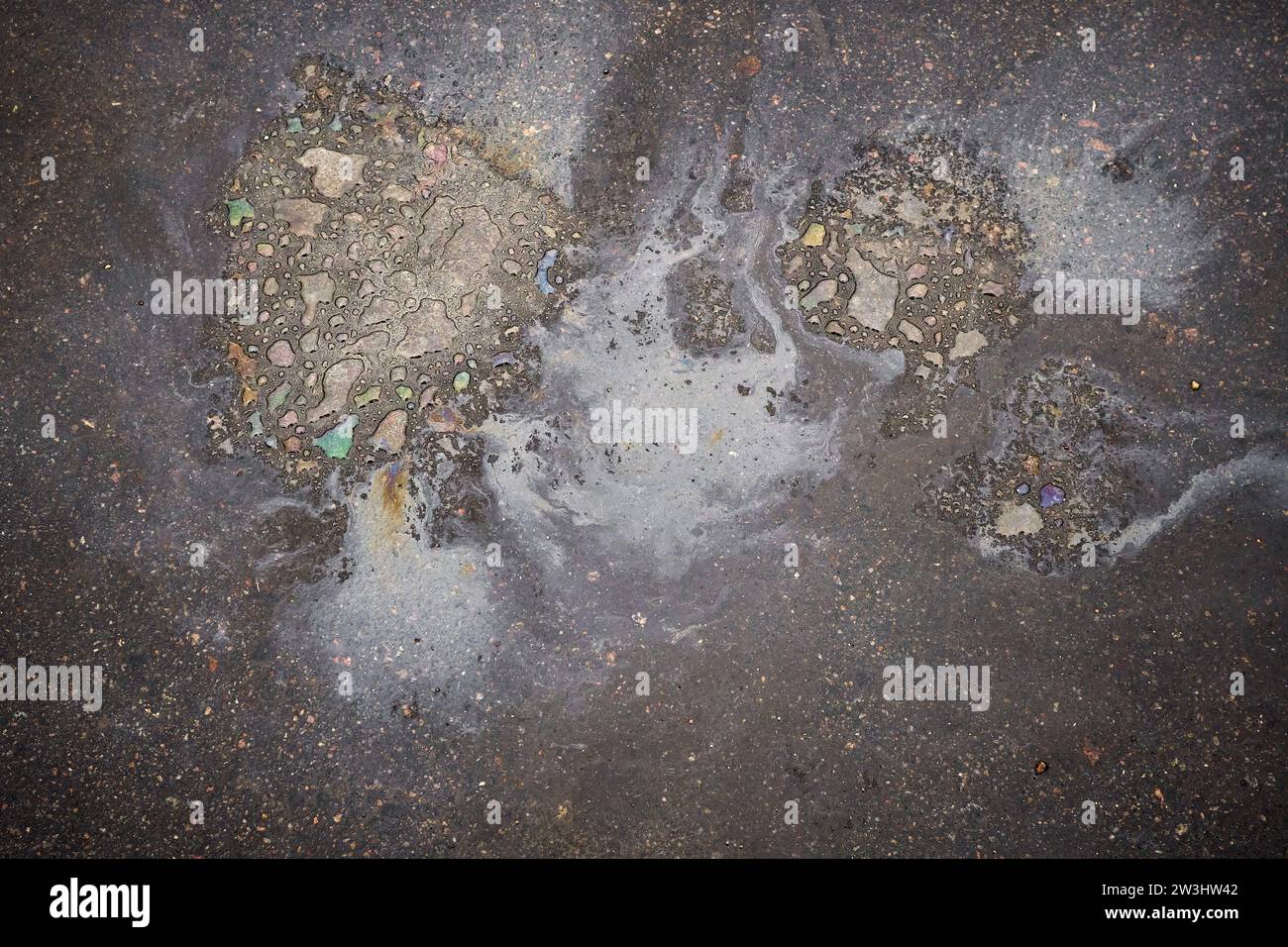 Colored oil stains close up, the color of the gasoline stain on the ...