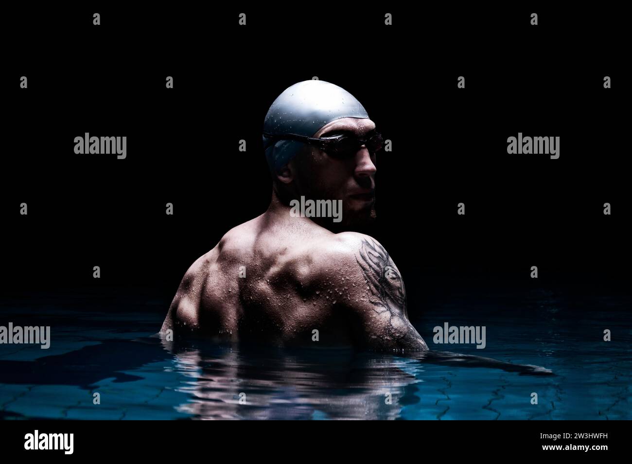 Portrait of a swimmer on a black background. The concept of swimming ...