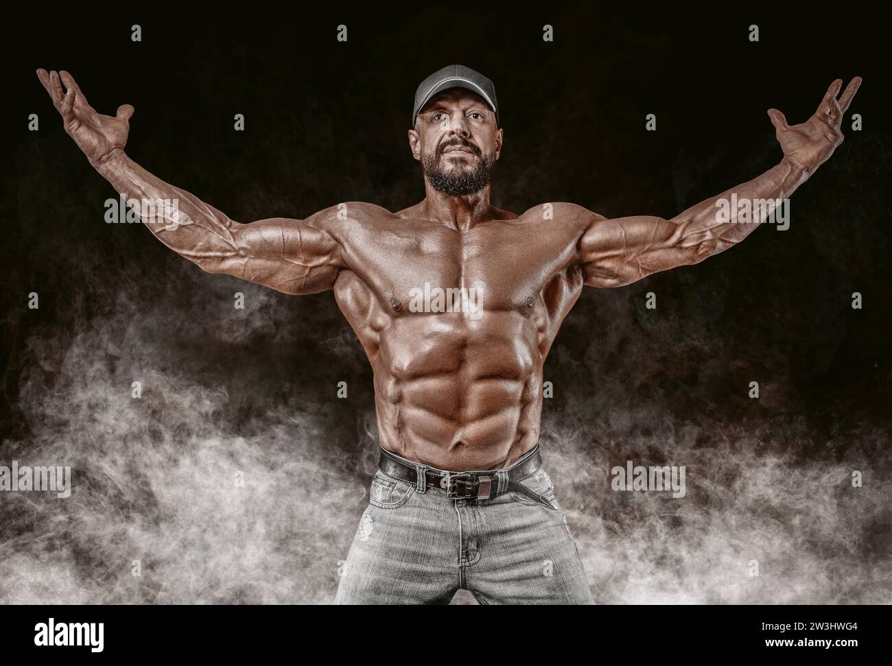 Muscular athlete posing in the studio. Fitness and classic bodybuilding ...
