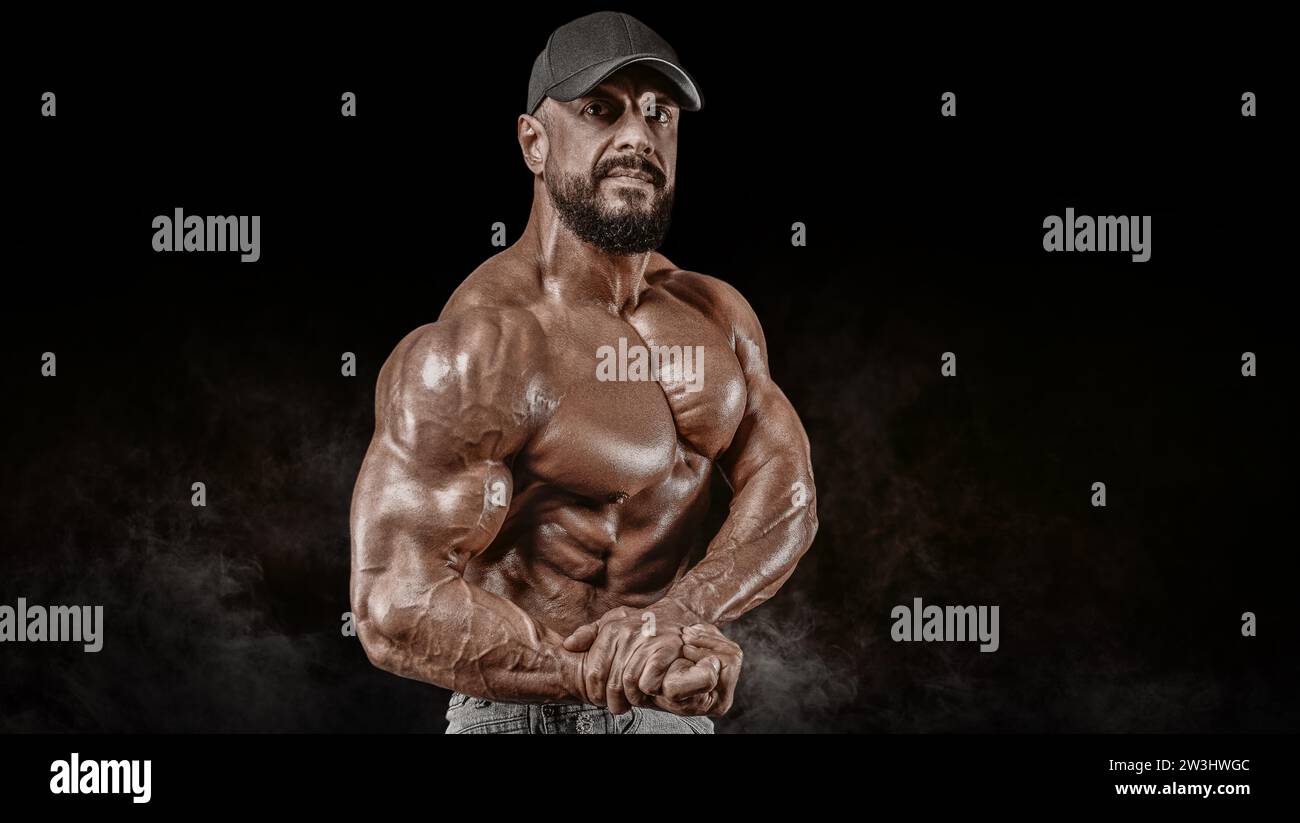 Muscular athlete posing in the studio. Fitness and classic bodybuilding ...