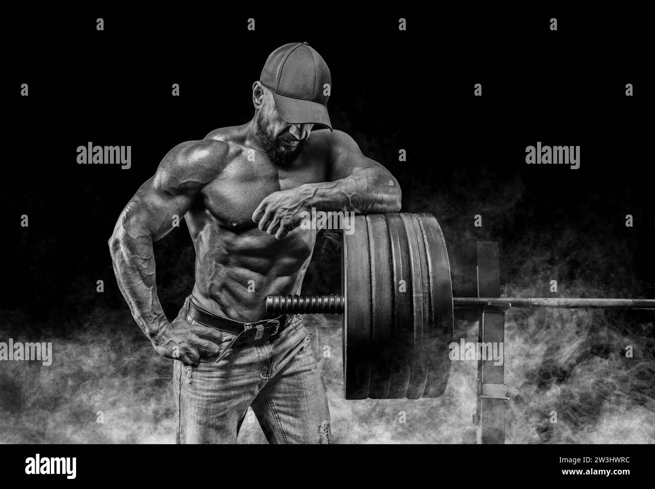 Muscular bearded man stands near the barbell. Bodybuilding, fitness ...