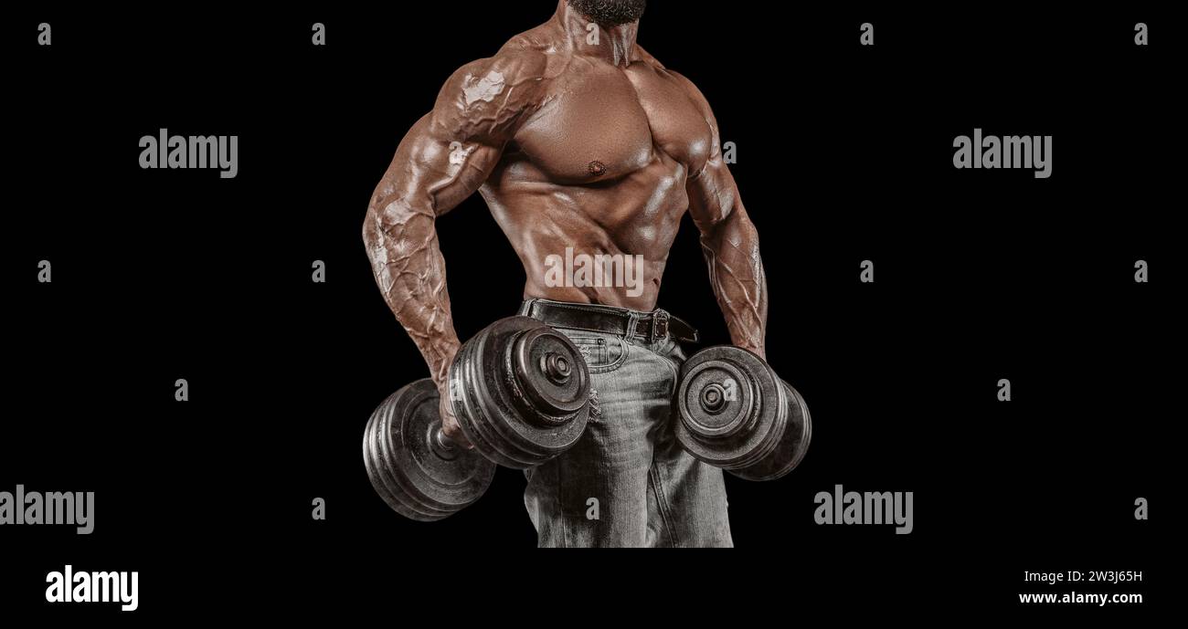 Muscular athlete posing in the studio with dumbbells. Fitness and ...