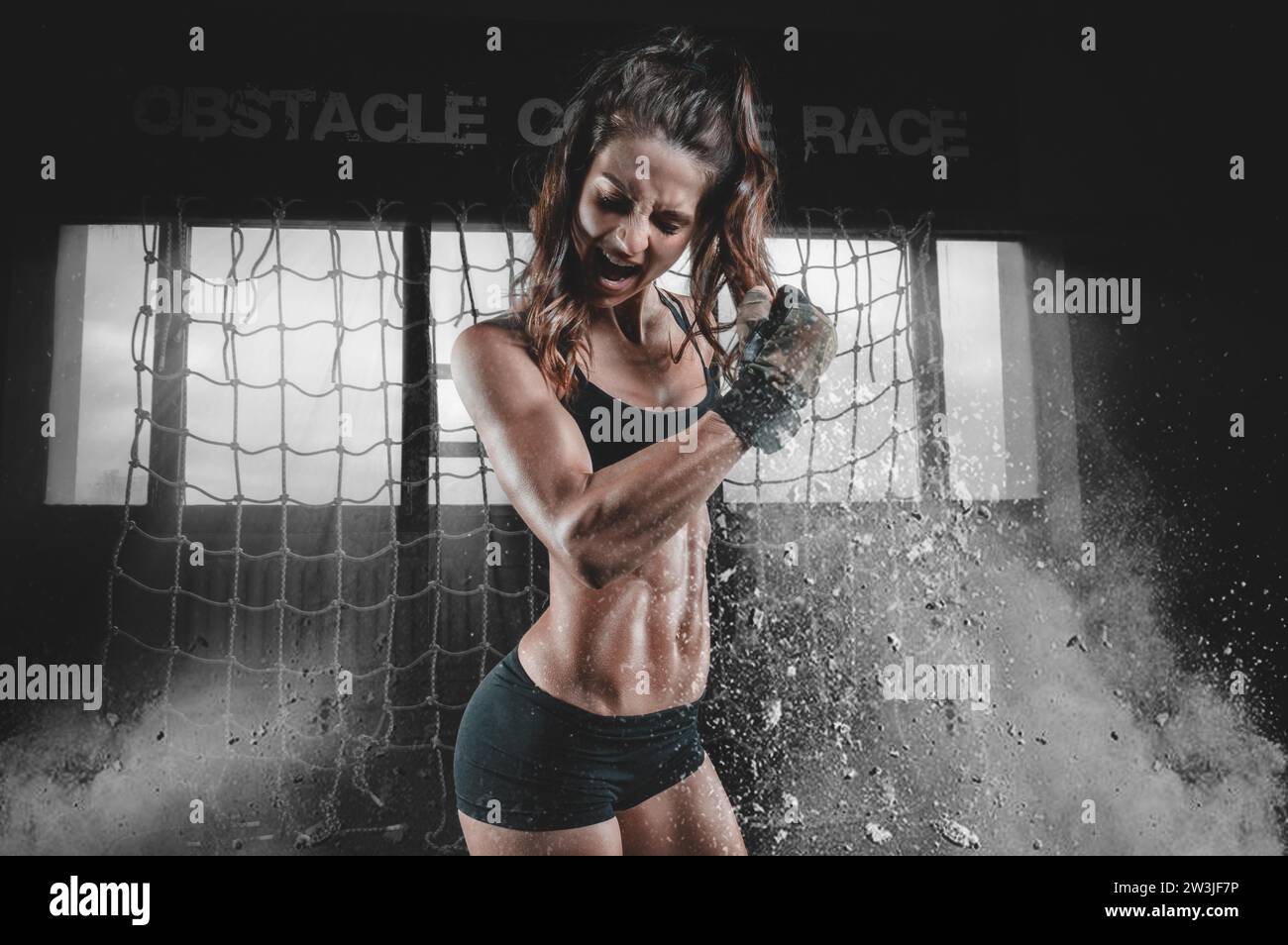 Strong muscular woman flexing her biceps after training. The concept of shaping, bodybuilding ...