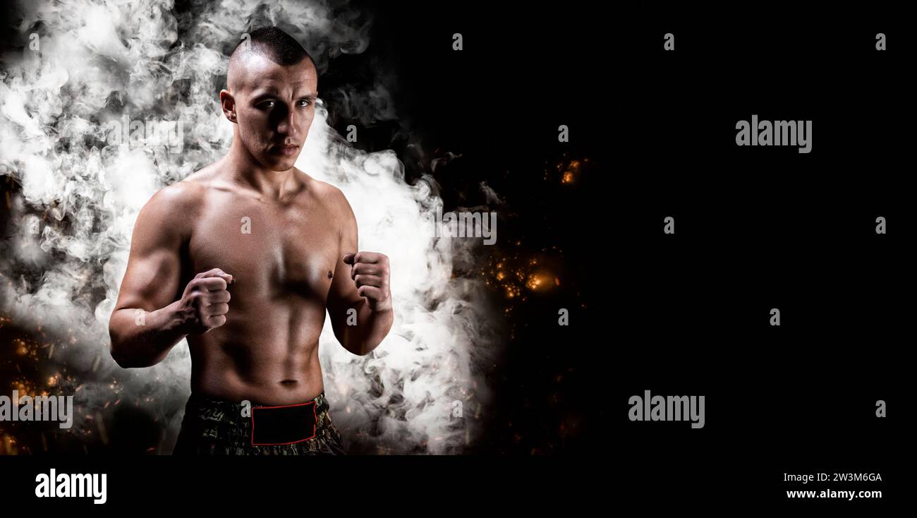Portrait of a boxer of mixed martial arts standing on the background of ...