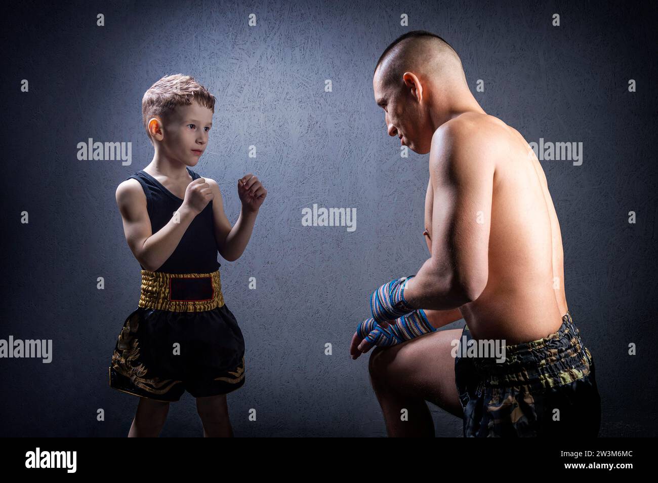 Kickboxing coach is training the boy. The concept of family, sports ...