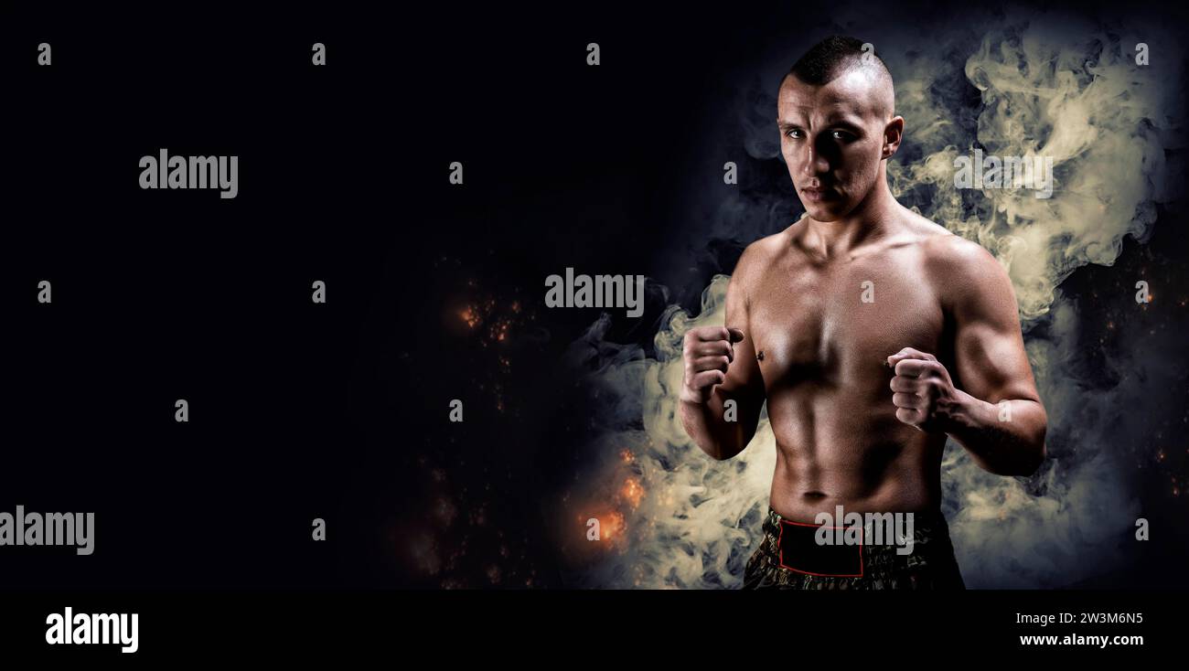 Portrait of a boxer of mixed martial arts standing on the background of ...