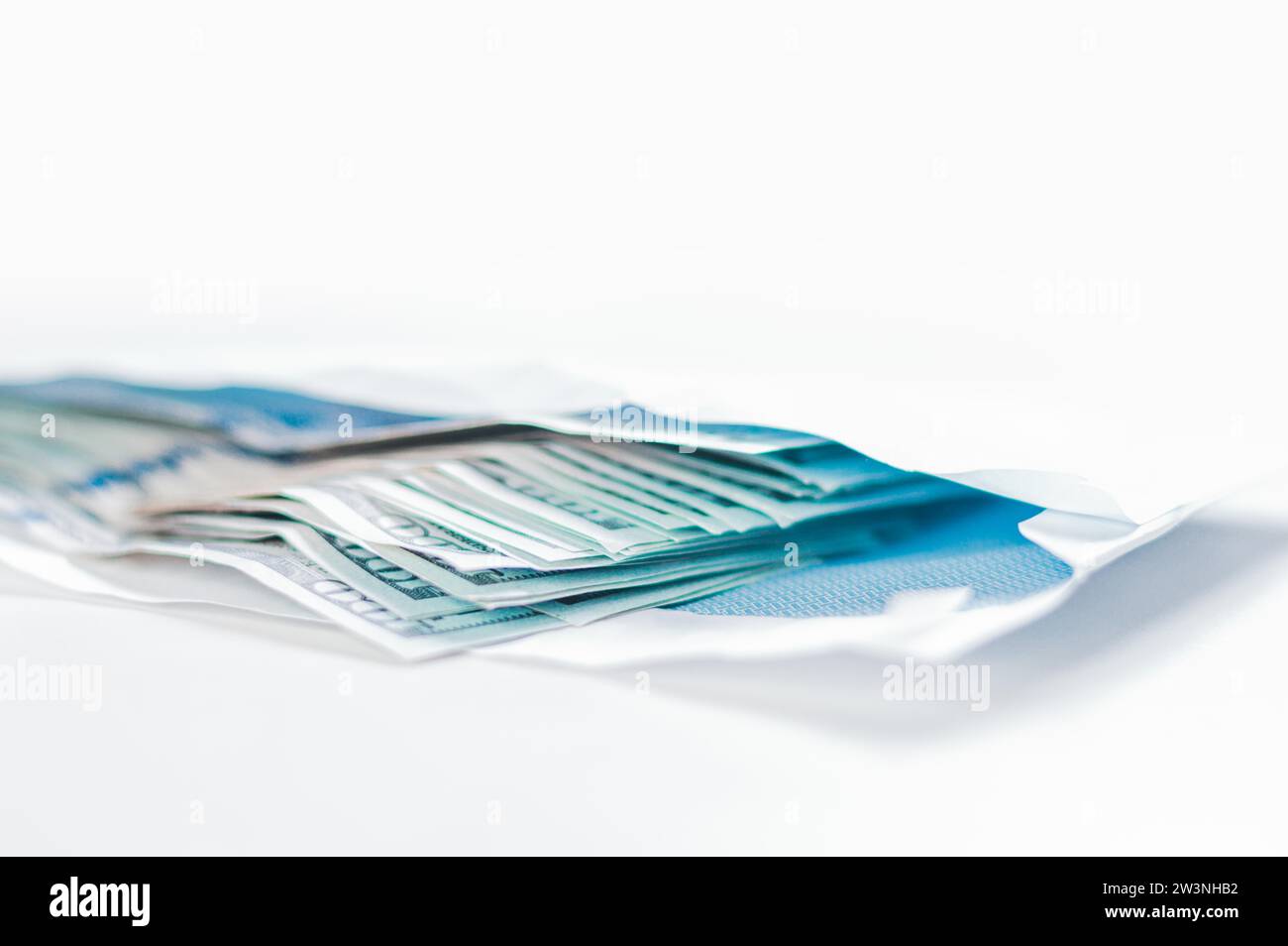 Pack of hundred-dollar bills lies in an envelope. The concept of ...