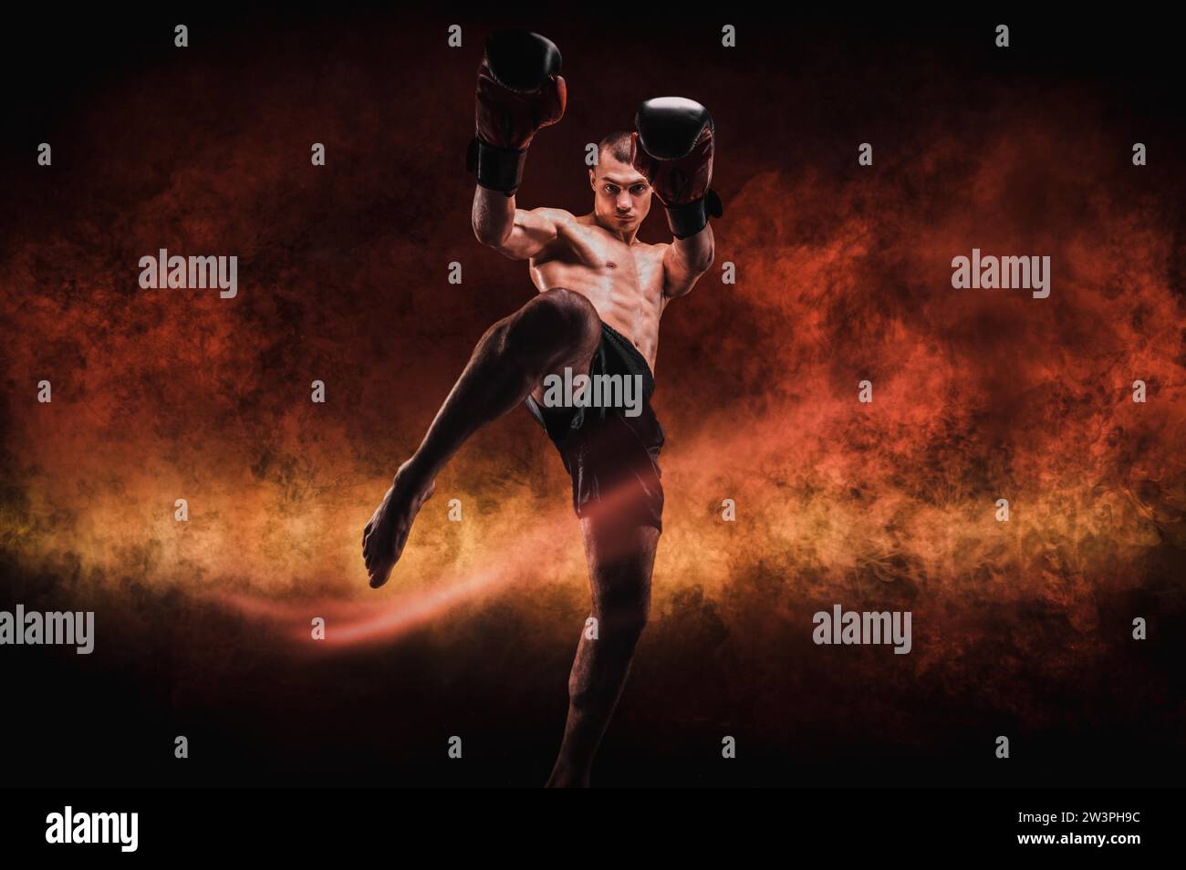 Image of a kickboxer in a fiery arena. Knee kick. Mixed martial arts ...