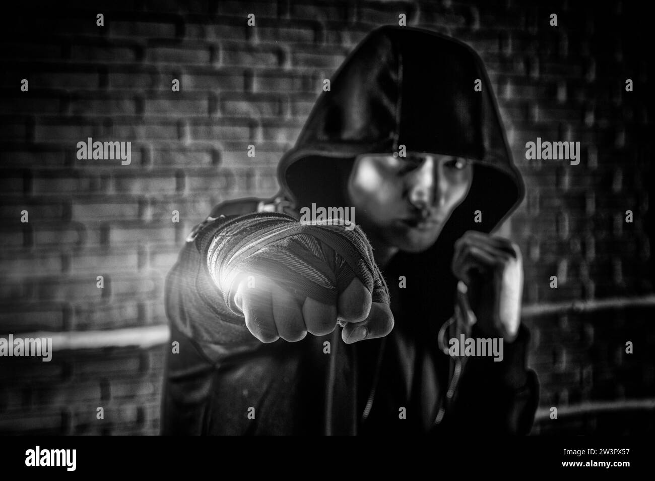 Boxer in a black sweatshirt and bandages wound on his hands beats his ...