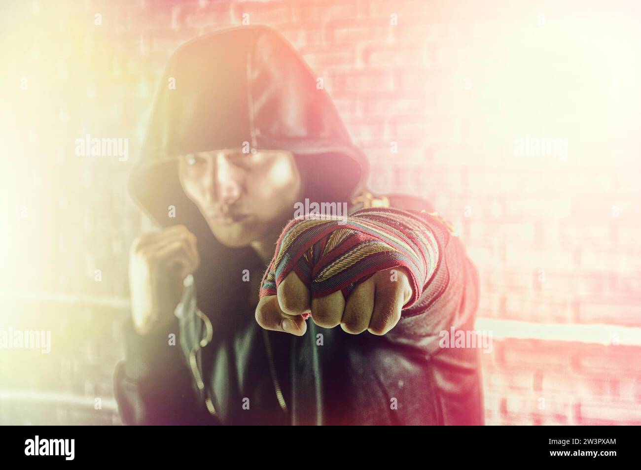 Boxer in a black sweatshirt and bandages wound on his hands beats his ...