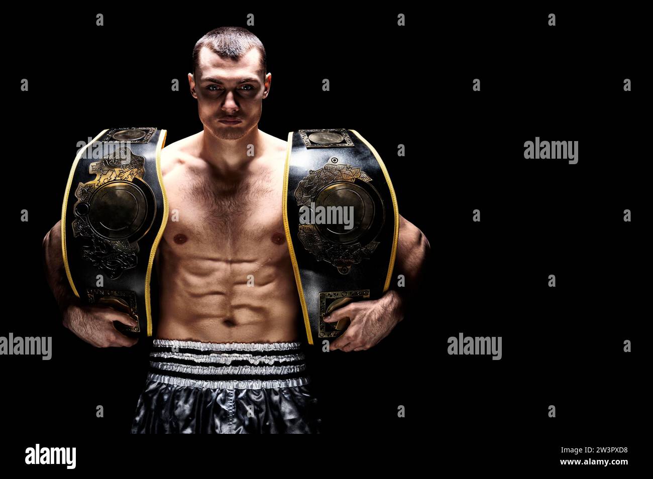 Kickboxing world middleweight champion stands with two belts. The ...