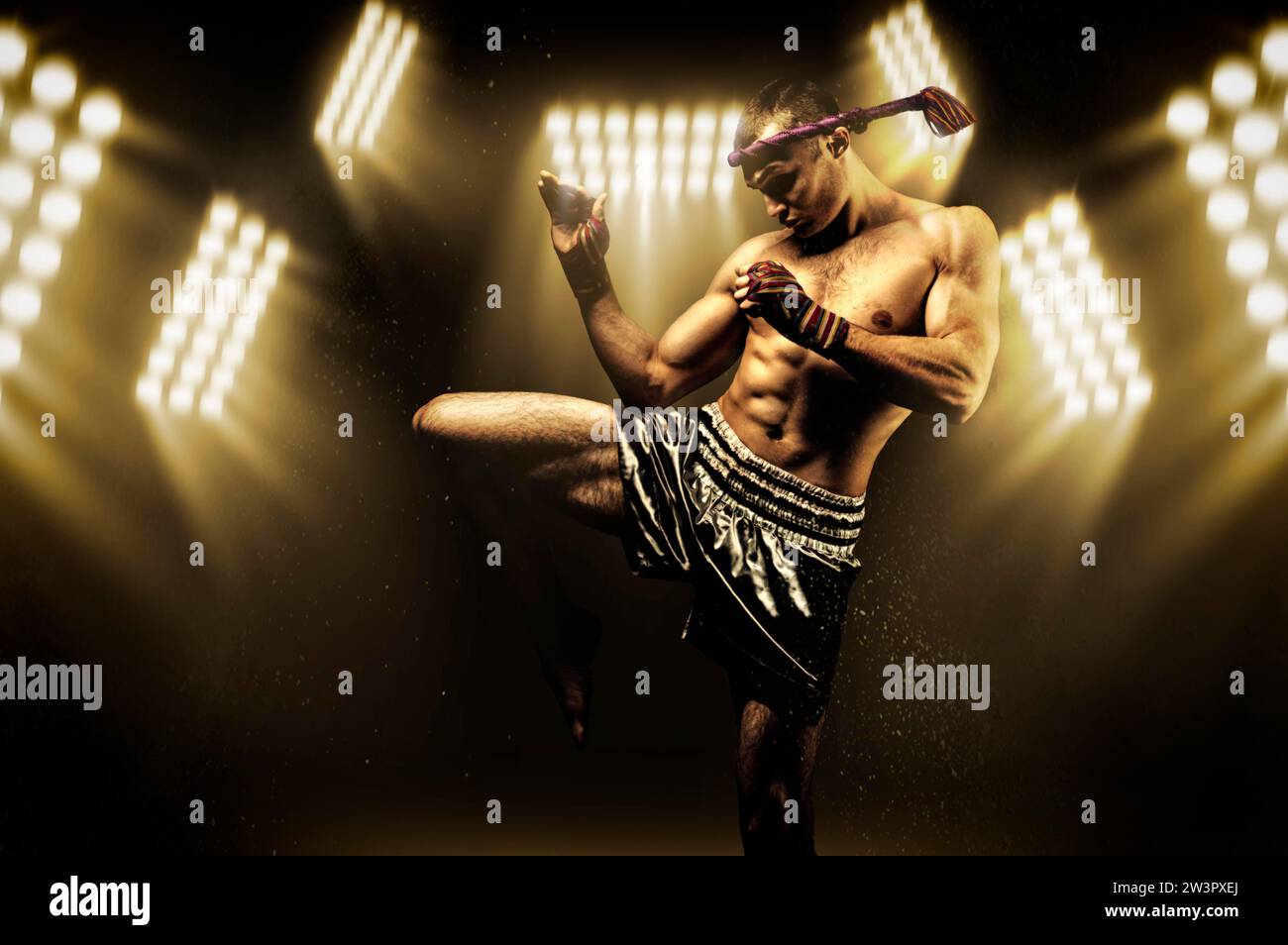 Kickboxer in the ring surrounded by searchlights stretches before the ...