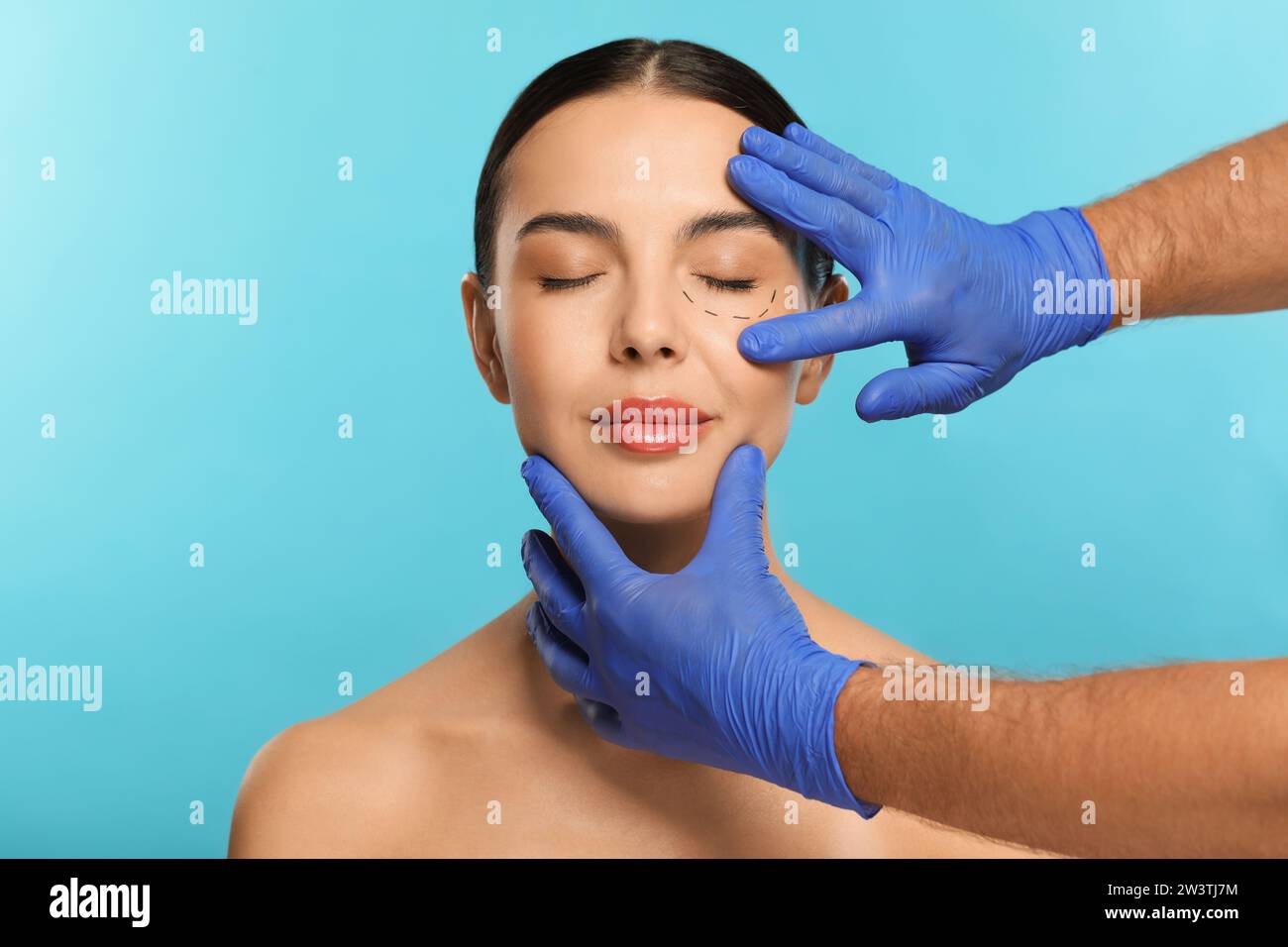 Doctor checking patient's face before cosmetic surgery operation on ...