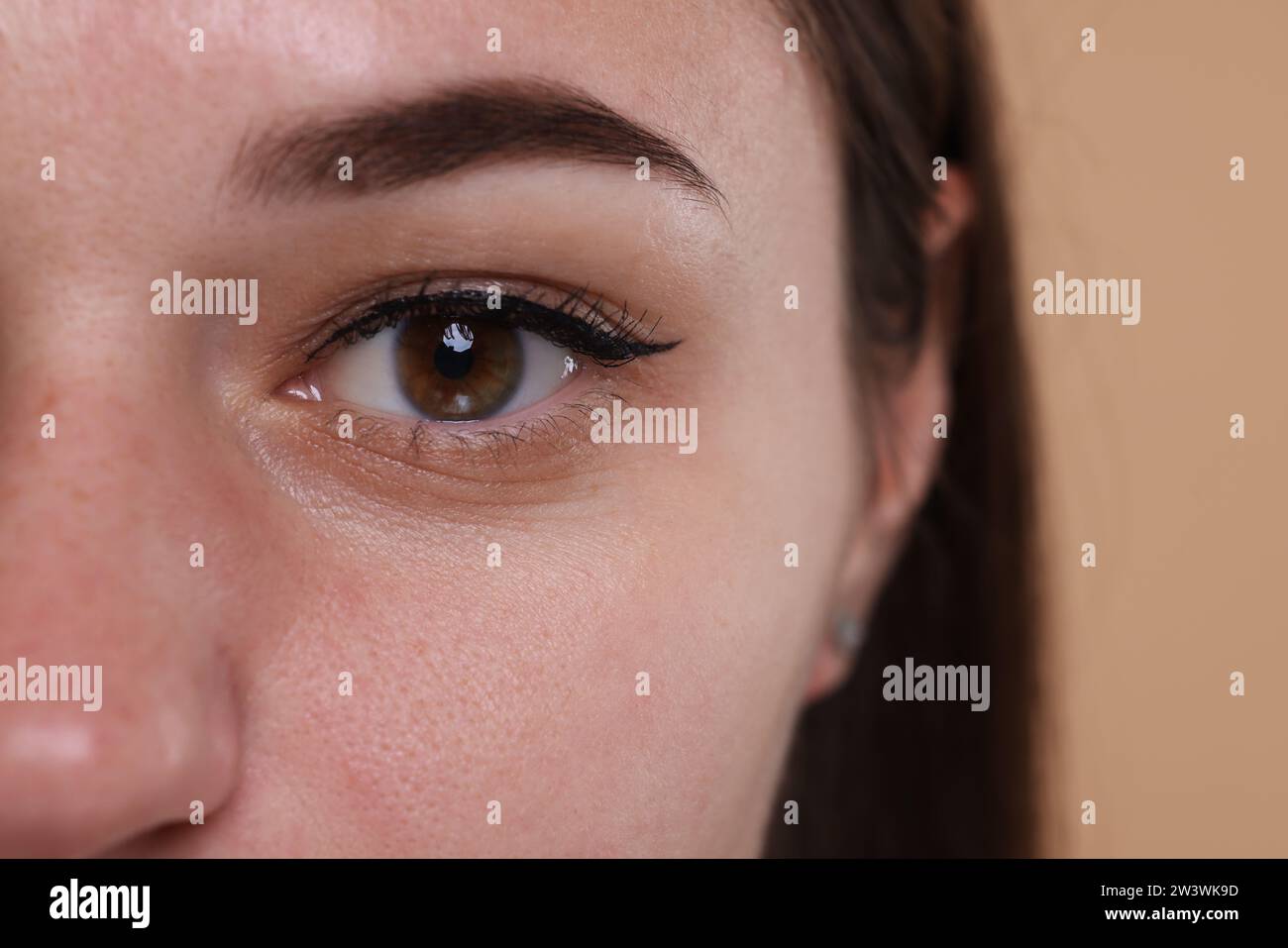 Closeup View Of Woman With Beautiful Hazel Eyes On Beige Background
