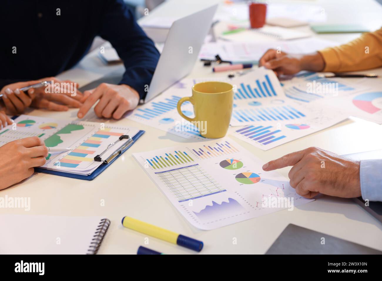 Team of employees working with charts at table, closeup. Startup ...