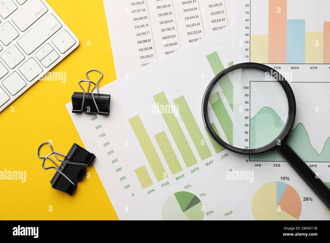 Accounting documents, magnifying glass, computer keyboard and binder ...