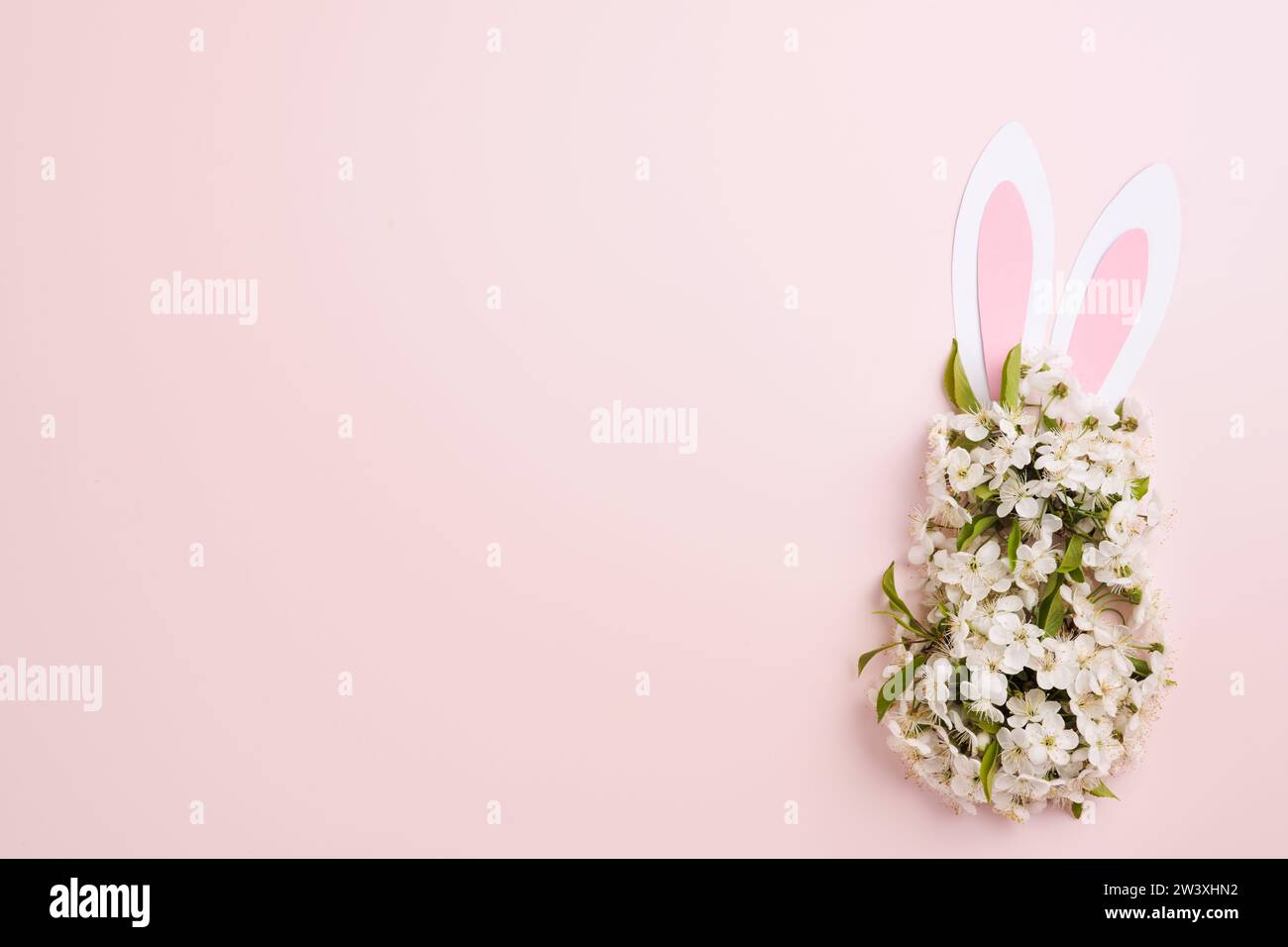 Happy Easter. Bunny rabbit ears made of pink paper and round bouquet of ...