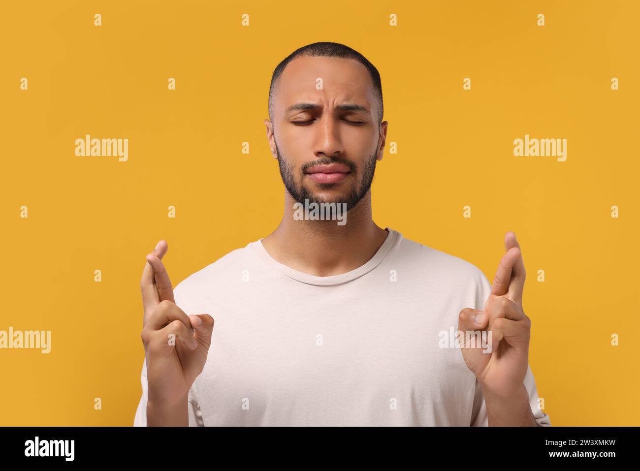 Young hopeful man crossing hi-res stock photography and images - Alamy