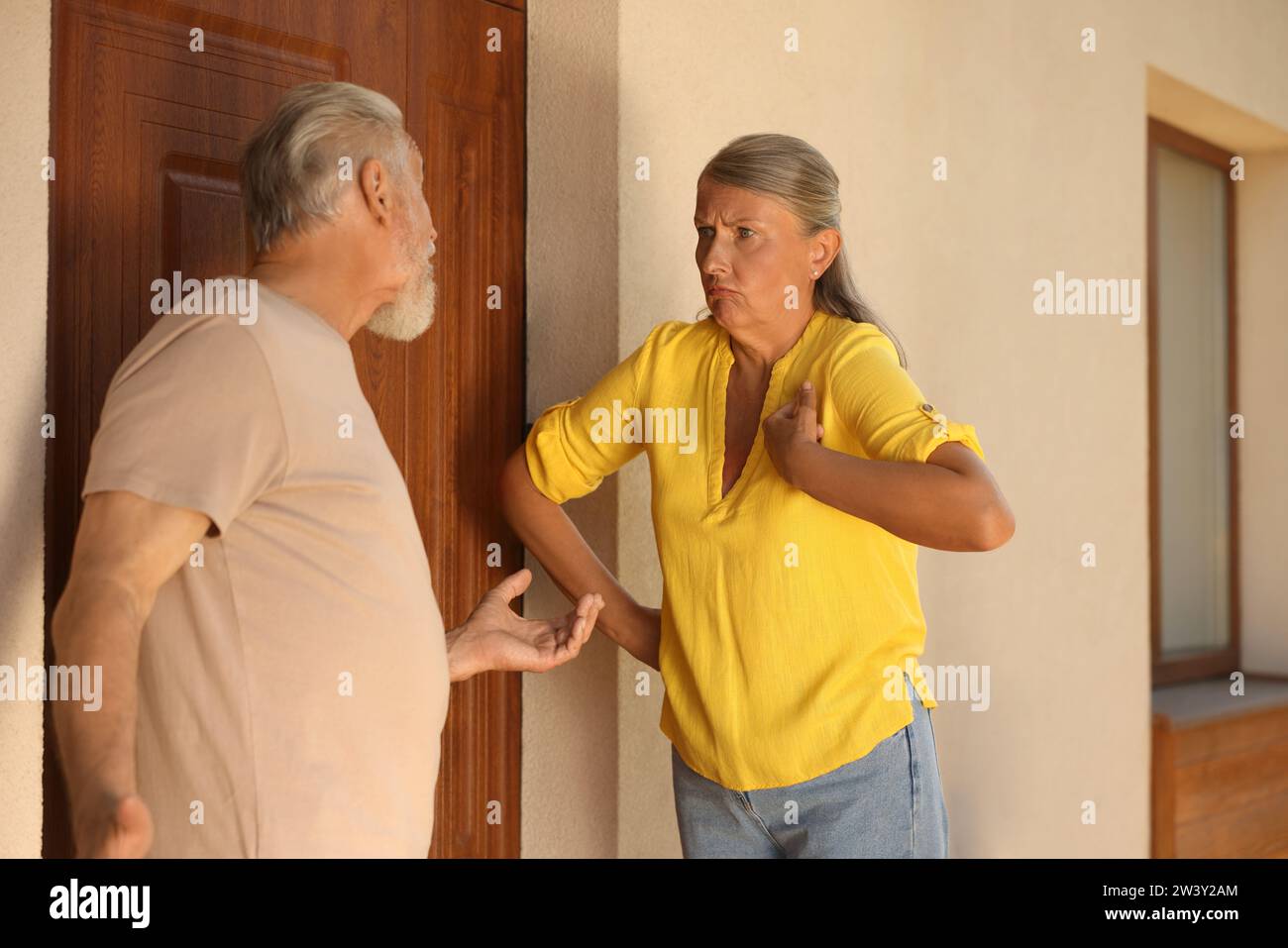 Emotional neighbours having argument near house outdoors Stock Photo ...