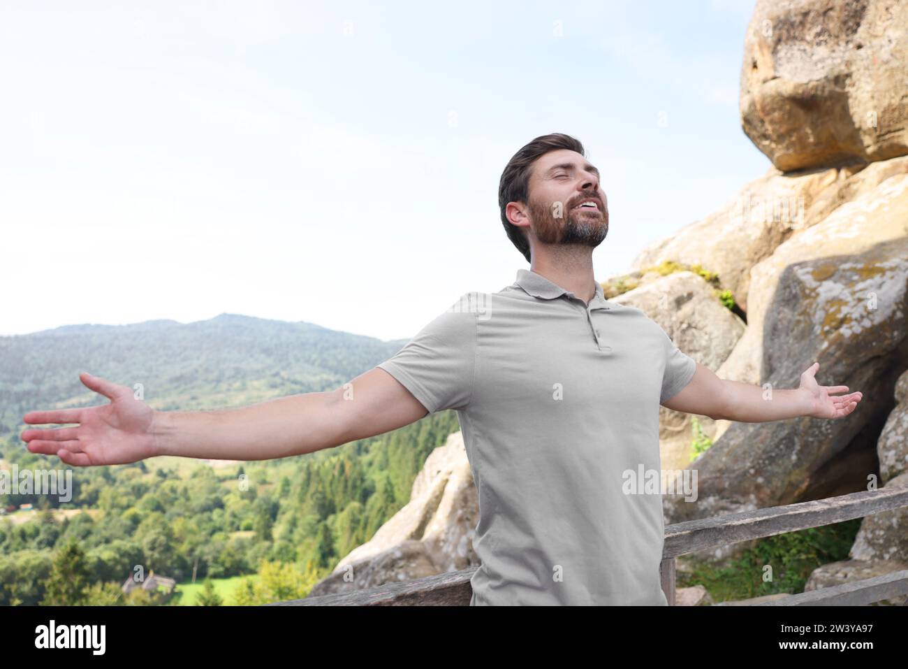 Feeling freedom. Man with wide open arms in mountains Stock Photo - Alamy