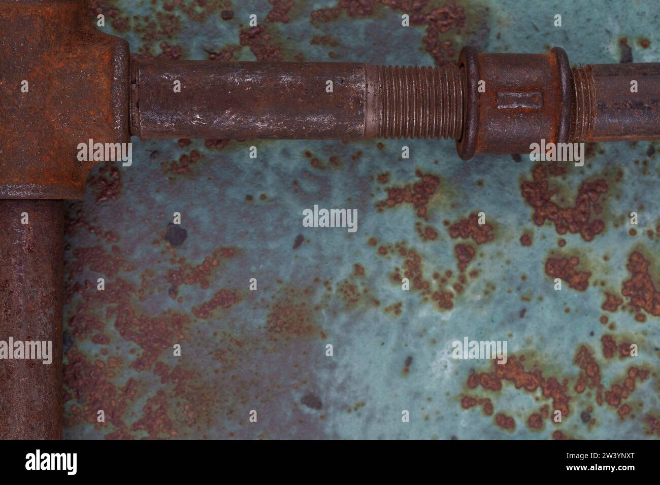 Rusty plumb tube on rusty metal wall background Stock Photo - Alamy