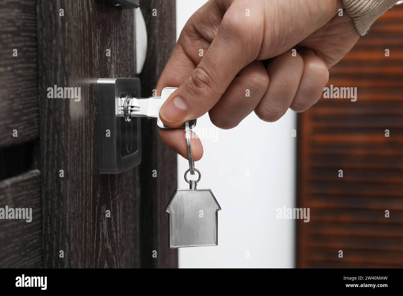 Man unlocking door with key, closeup view Stock Photo - Alamy
