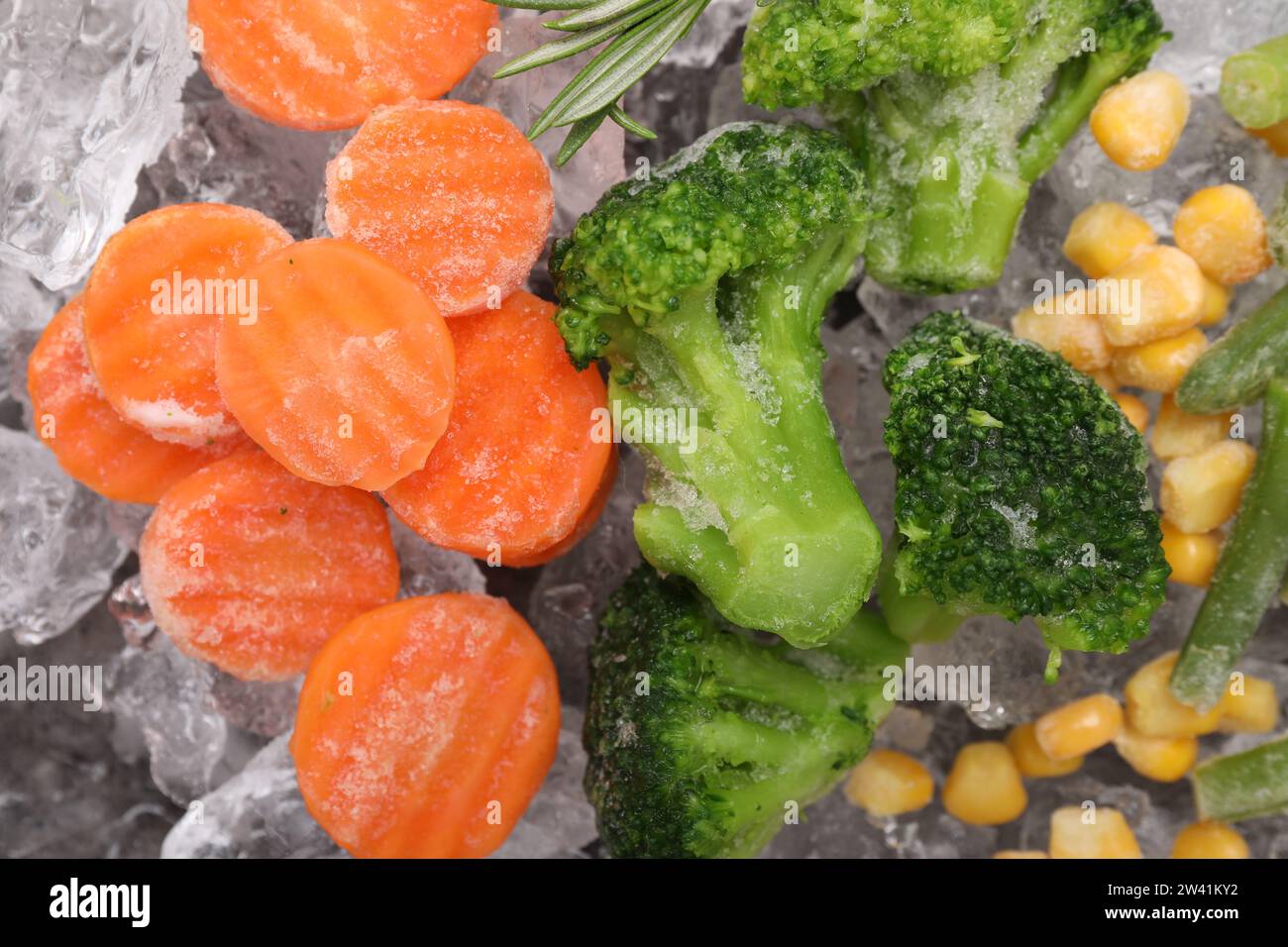 Different frozen vegetables on ice, flat lay Stock Photo - Alamy